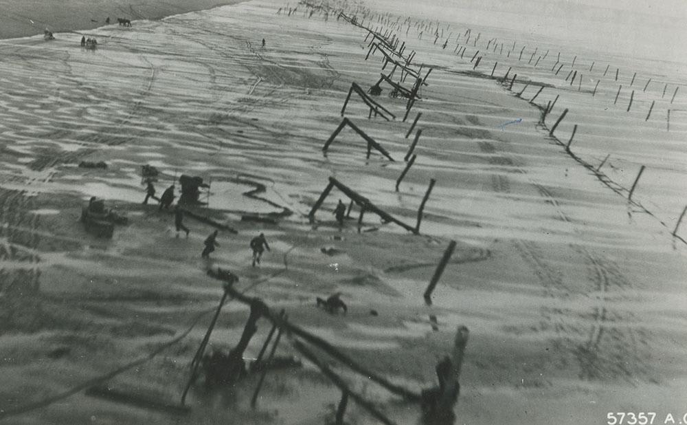 German engineers on Omaha Beach setting up obstacles take cover as an ...