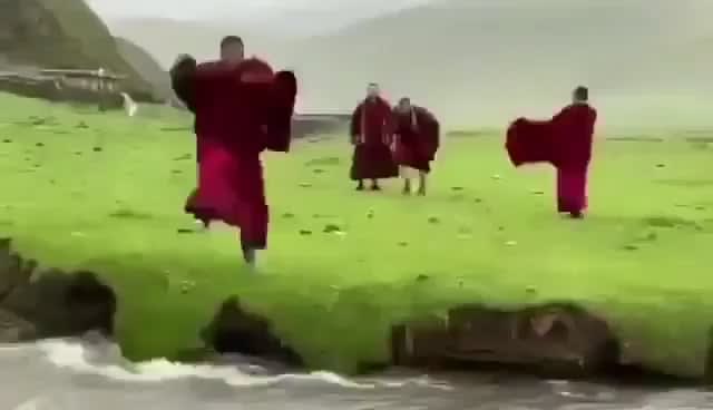 Monks jumping over a stream