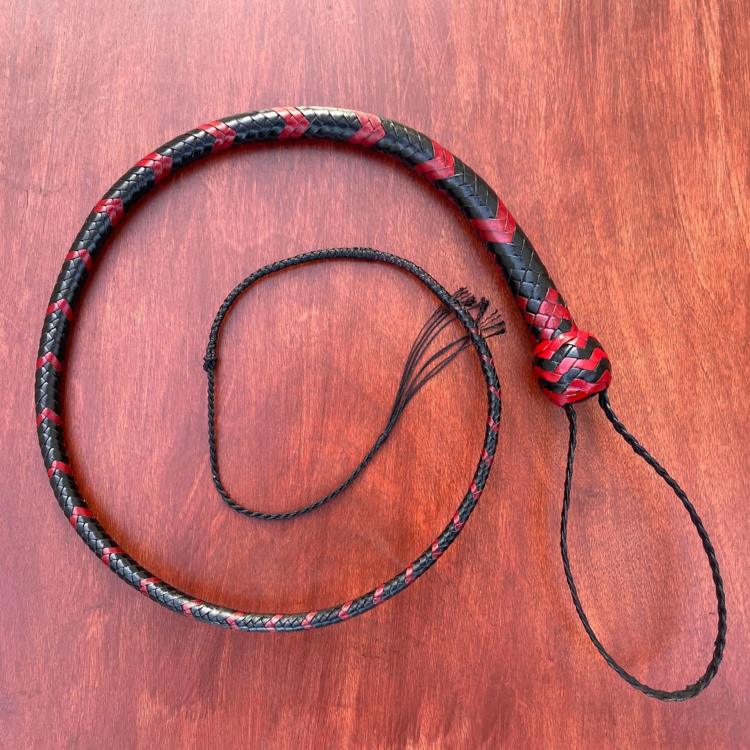A 3 foot 12 plait Main Gauche signal whip in black and red, with a 4 ...