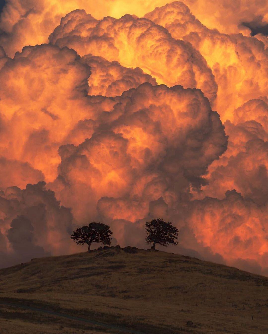 Towering thunder clouds that were captured during a sunset created the ...