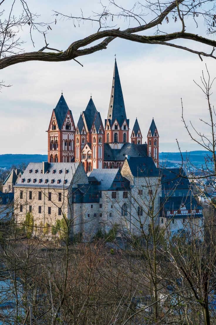 Limburg Castle and rising above it the colorful towers of Limburg ...