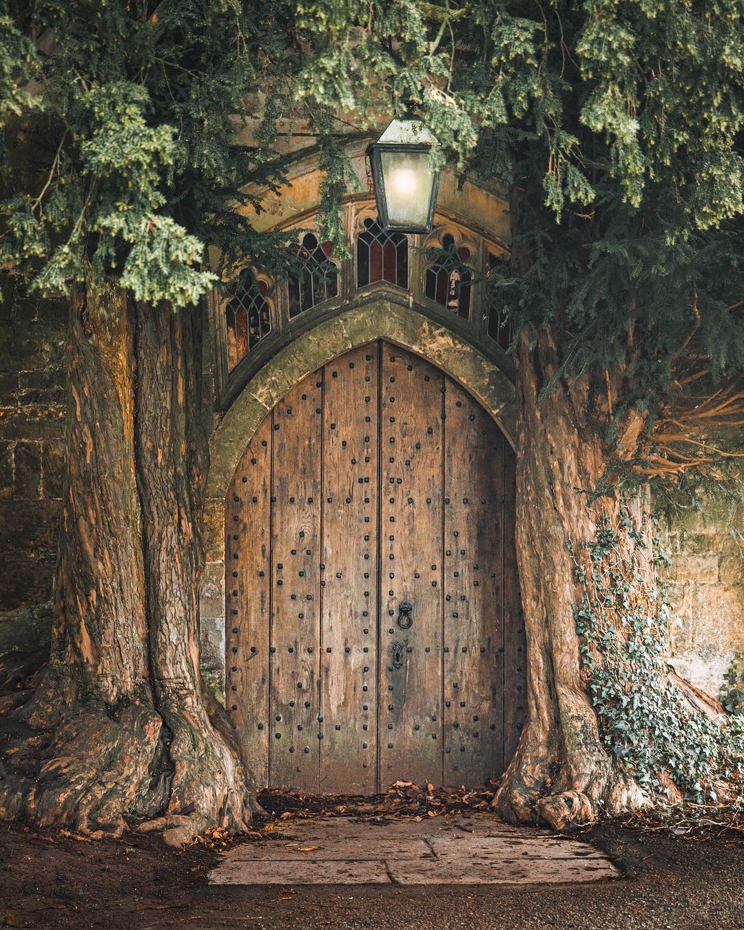 Tolkienesque entrance of the 11th century St Edward's Church flanked by ...