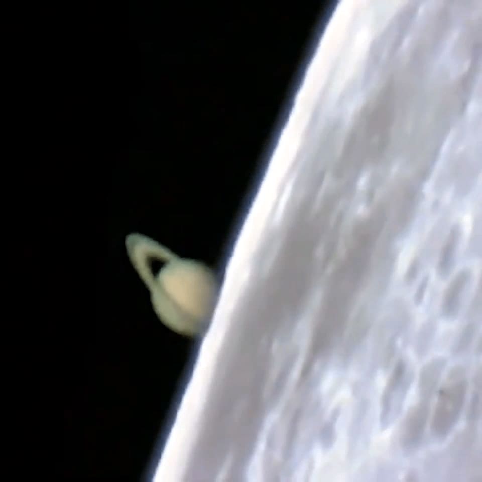 Saturn rising from behind the Moon during a lunar occultation. Captured ...
