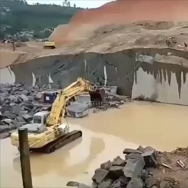 Excavator pulling a slab out