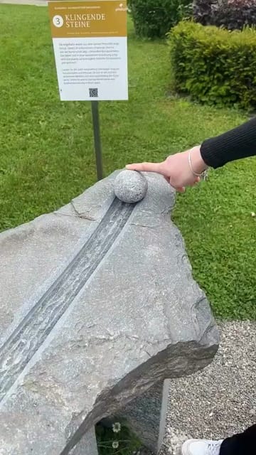 An Archaeologist demonstrates a pre-historic music 'Lithophone ...