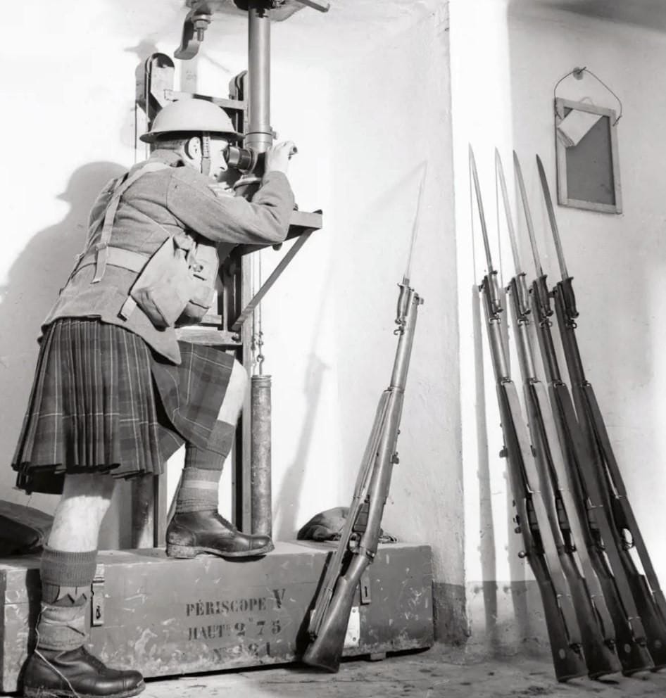 A soldier from the Cameron Highlanders looks through a periscope in the ...