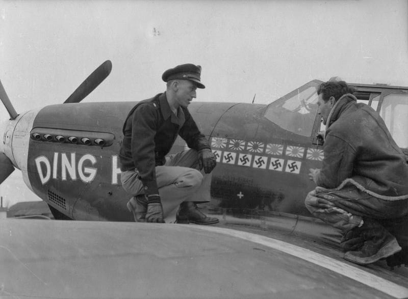 Lt. Col. James Howard examines the kill markings on his P-51 Ding Hao ...
