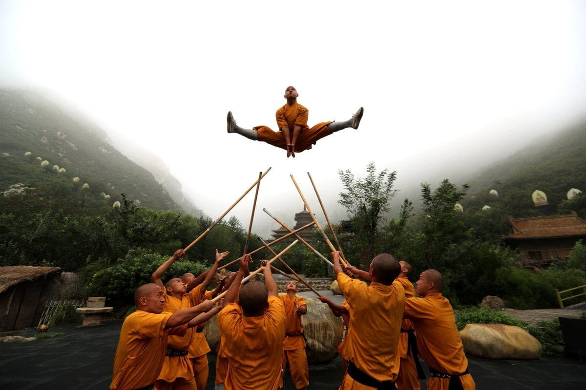 Shaolin boys practice kung fu in the sweltering heat during the zen ...