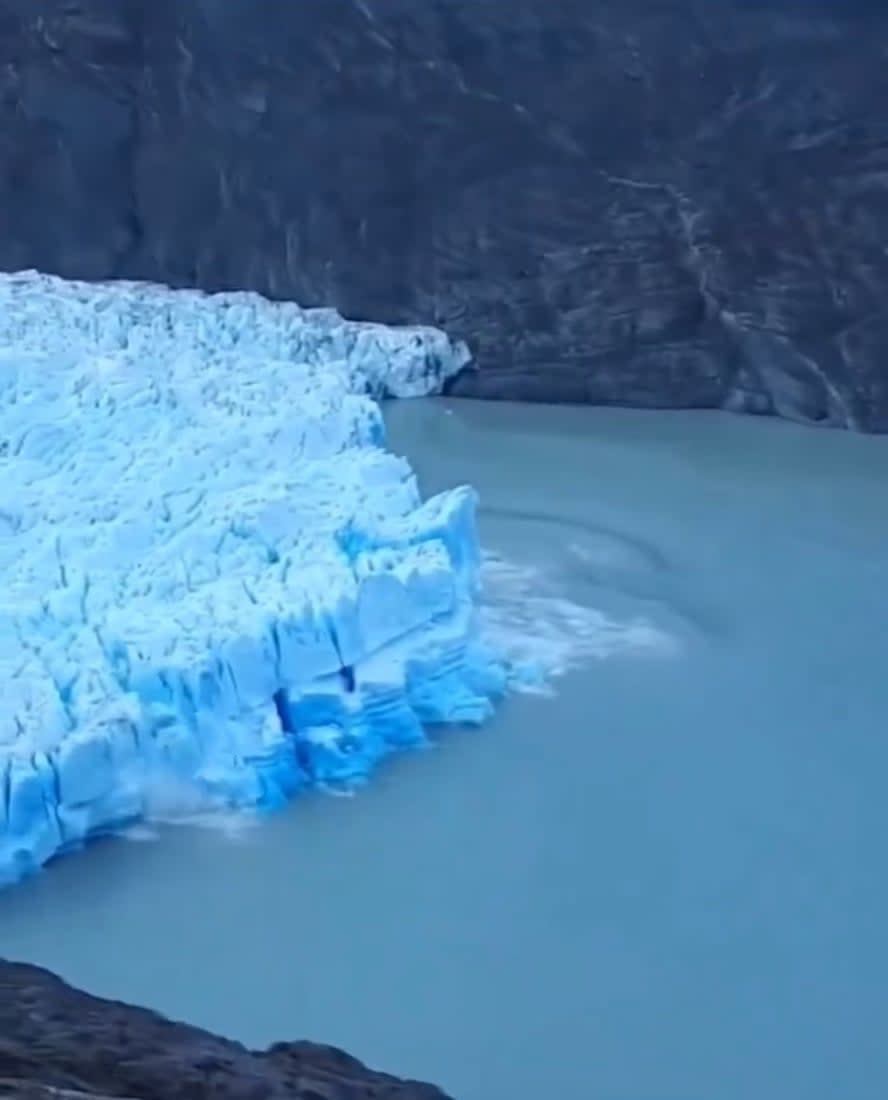 Rare sighting of the deep blue underside of a glacier during a collapse ...