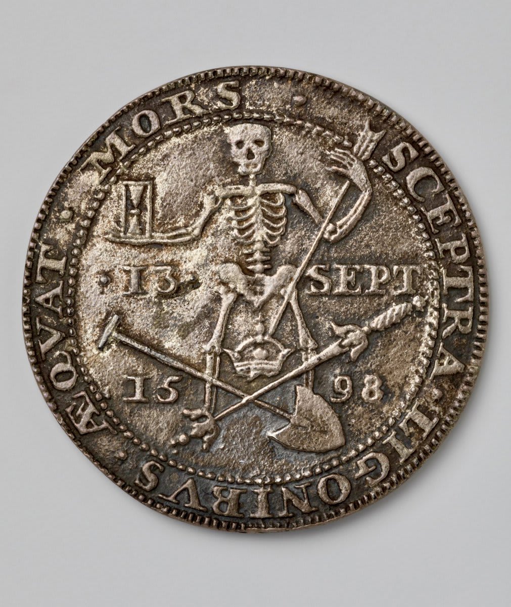 A skeleton stands with an hourglass and a large arrow on this silver ...