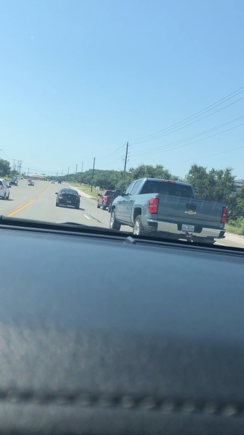 Black car harasses red landscaping truck for several minutes, yelling ...