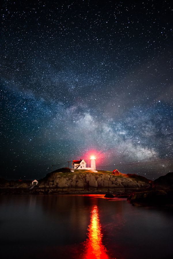The milky way rises over the Nubble Lighthouse in Cape Neddick Maine ...