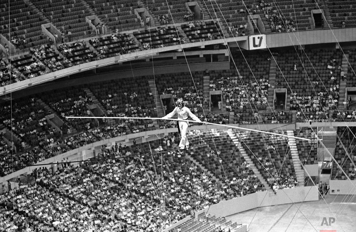 French high wire artist Philippe Petit walks across the cable some 200 ...