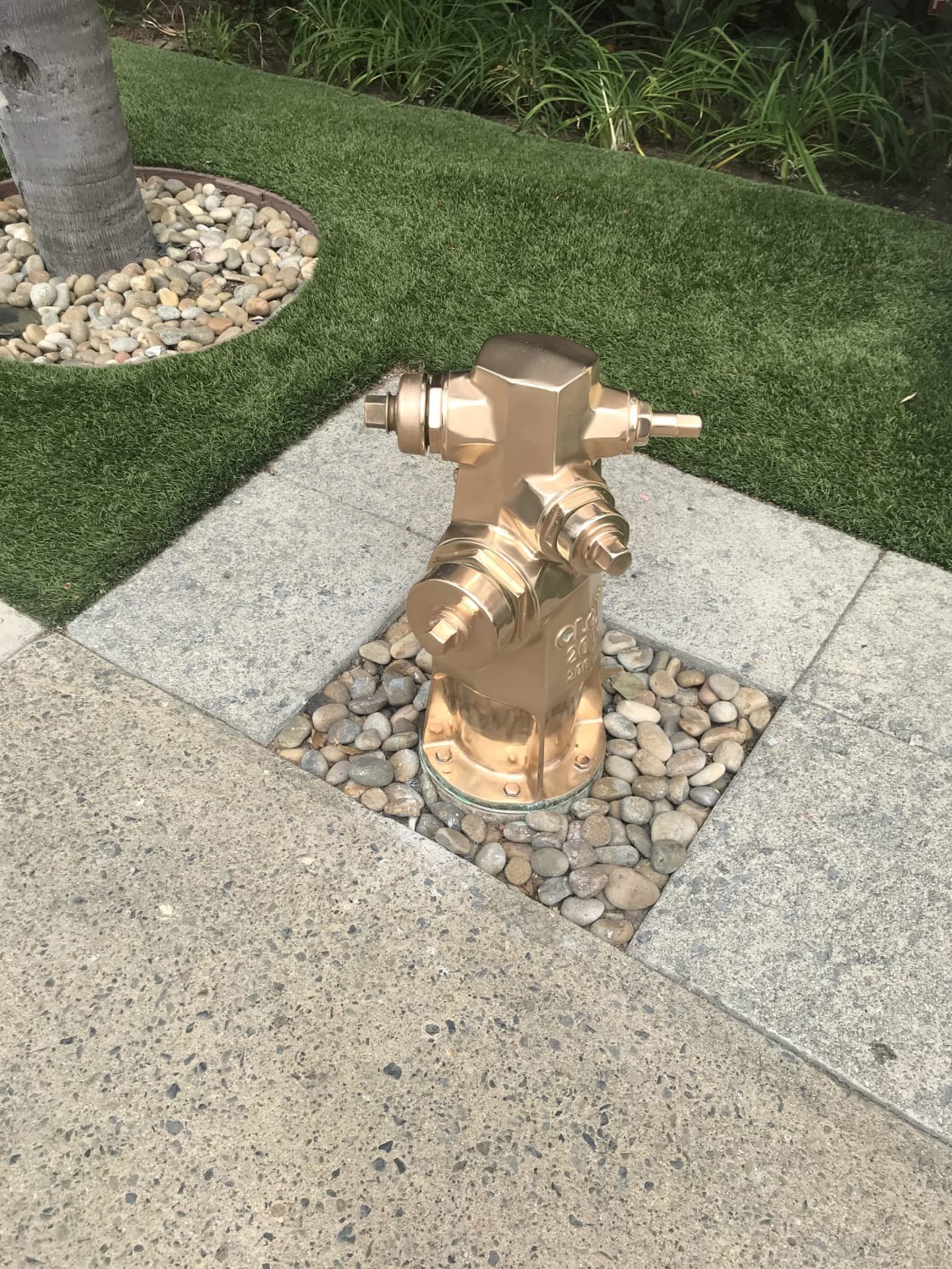This brass plated fire hydrant outside a fancy hotel