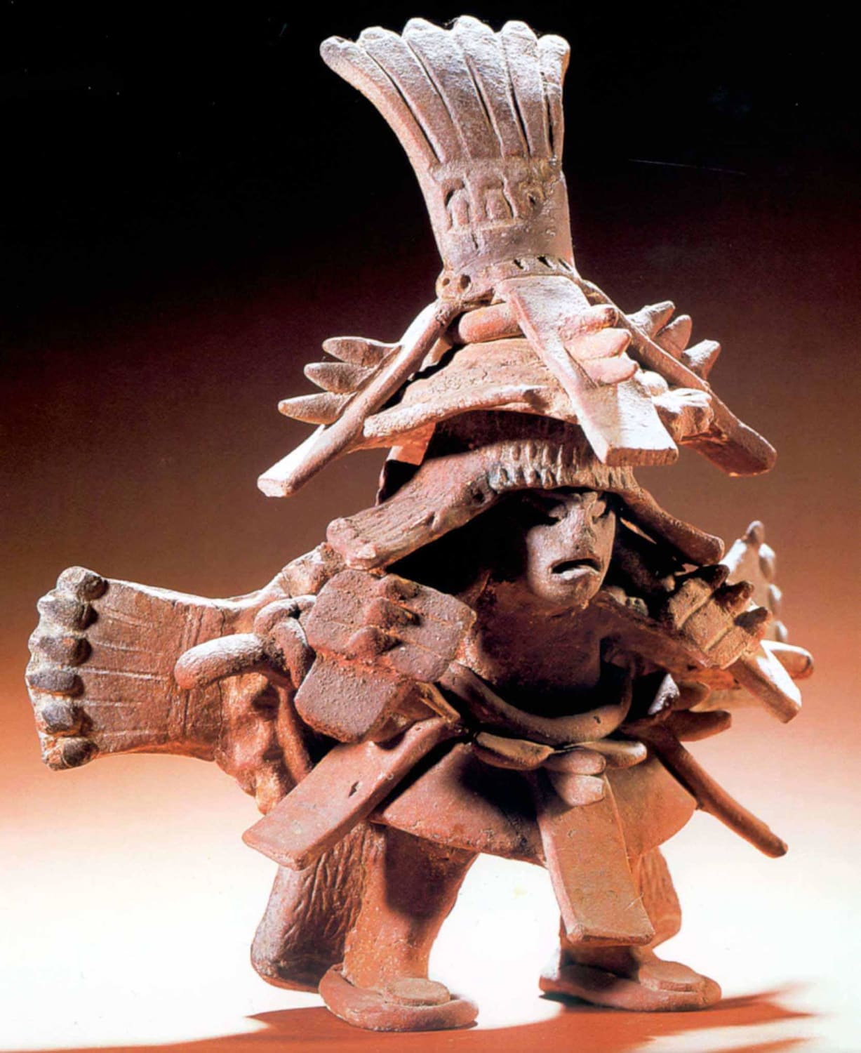 A ceramic figure of a sumptuously dressed warrior, from the Totonac ...