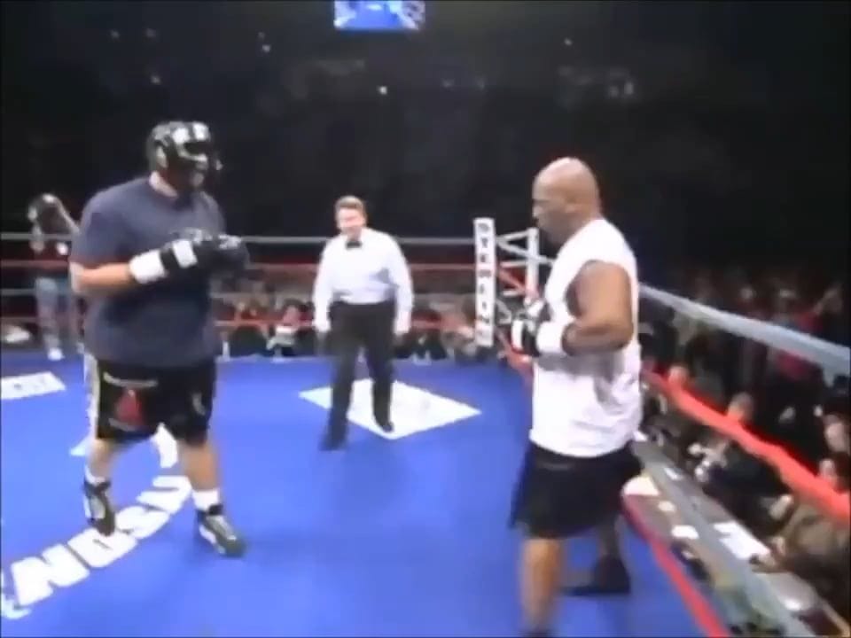Mike Tyson holding up a nearly knocked down opponent in a charity ...