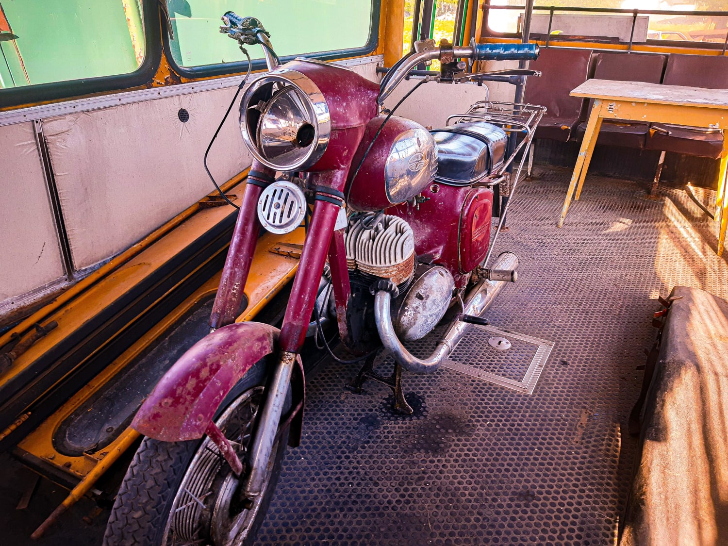 Old Java motorcycle inside an abandoned soviet bus